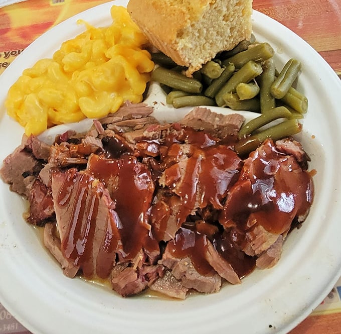Brisket sliced thin with that telltale pink smoke ring, draped in sauce and flanked by mac and cheese that's definitely not from a box.