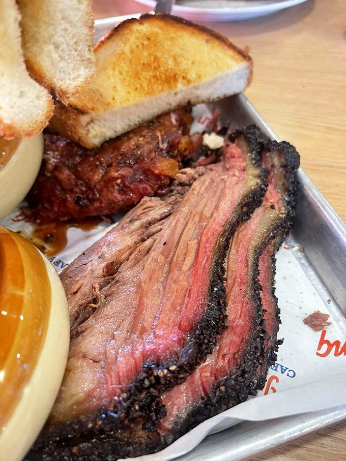 This brisket has the kind of smoke ring that barbecue aficionados dream about. That beautiful pink edge is basically a diploma from Meat University.