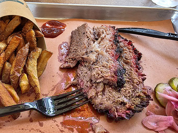 Brisket with that coveted pink smoke ring that BBQ aficionados chase like treasure hunters, served with no-nonsense pickled onions.