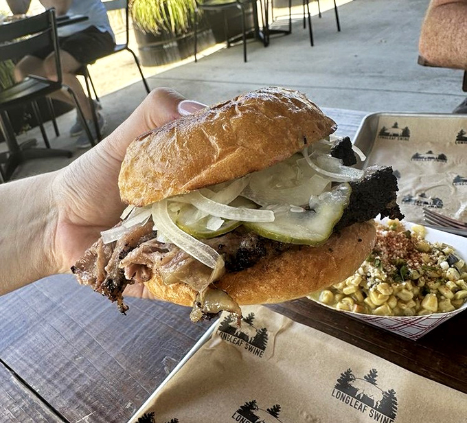 A proper brisket sandwich should make you pause mid-conversation, and this beauty with its pickles and onions demands your full attention.