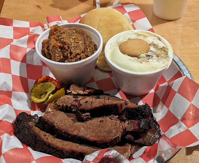 Brisket with that telltale pink smoke ring—nature's way of saying "patience pays off" alongside sides that refuse to be upstaged.