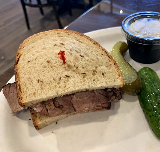 A brisket sandwich that doesn't need fancy trimmings to impress. Just meat, bread, and a pickle&mdash;sometimes simplicity is the ultimate sophistication.