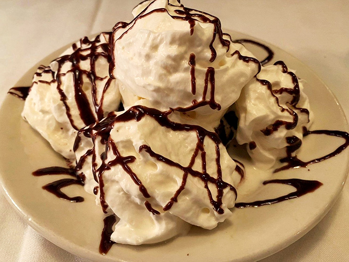 Cloud-like whipped cream drizzled with chocolate sauce&mdash;proof that after conquering a steak, there's always room for a little something sweet.