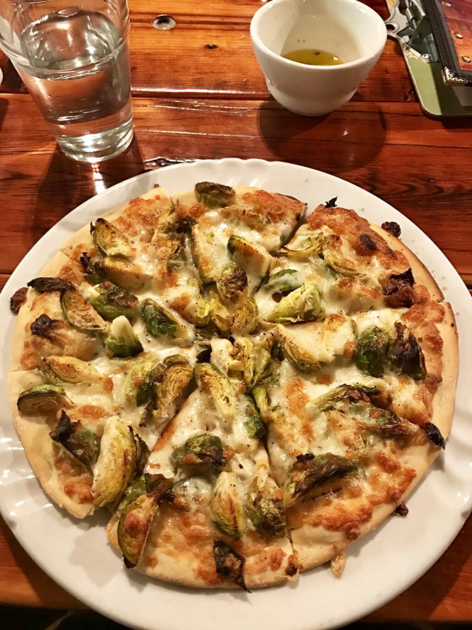 Brussels sprouts on pizza? Culinary rebellion never tasted so right. This pie converts vegetable skeptics faster than a tent revival.