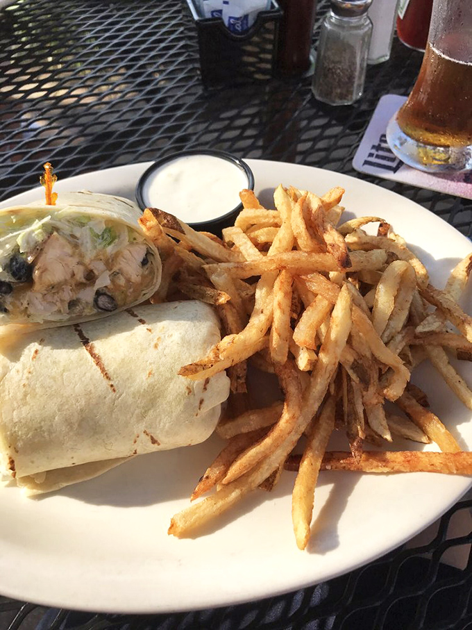 When a wrap means business: crispy chicken, fresh veggies, and fries that could stand alone as their own attraction.