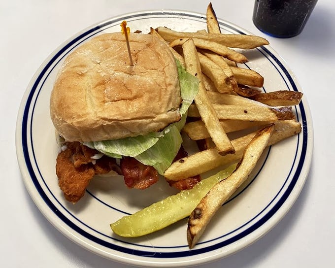 This isn't just a burger &ndash; it's architecture with pickles. The golden fries standing at attention nearby know they're in the presence of greatness.