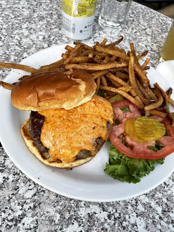 A burger that requires both hands and a strategy. Those fries look like they were sent from the potato gods themselves.