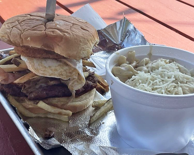The dynamic duo of comfort food: a towering burger paired with mac and cheese that dreams are made of.