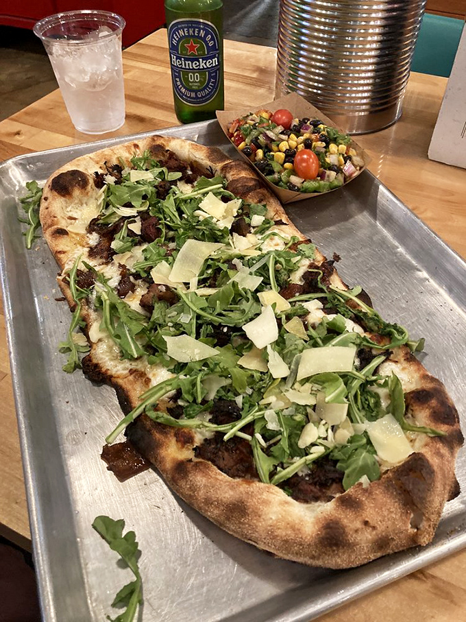Flatbread that dares to dream bigger, topped with arugula and what appears to be burnt ends&mdash;proof that BBQ and pizza were meant to be together.