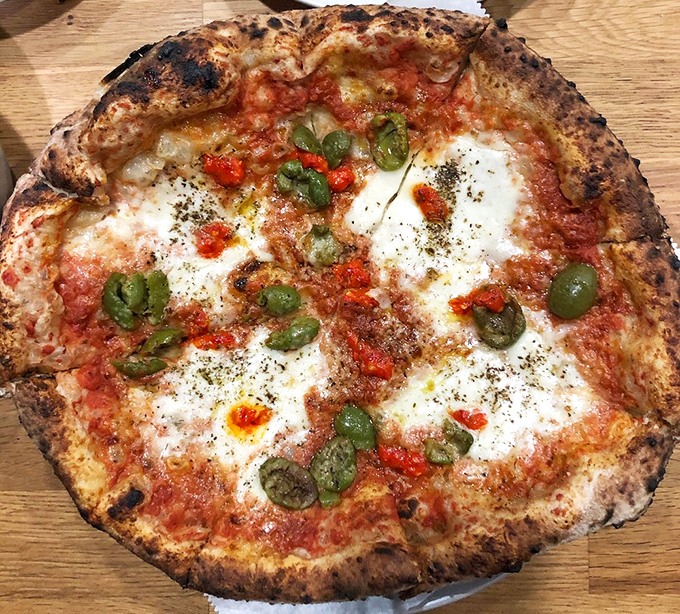 This burrata pizza is pure fire&mdash;blistered crust, creamy pockets of cheese, punchy green olives, and just the right heat from Calabrian chilies. Bestia knows exactly what it&rsquo;s doing.