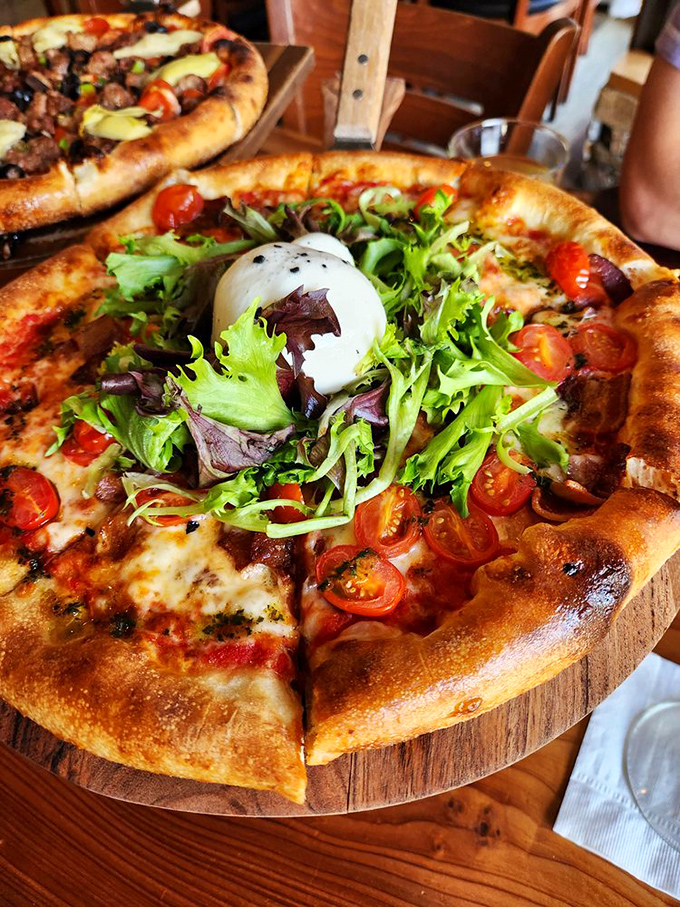 When a pizza wears a salad as a hat, you know you're in California. The burrata adds a creamy exclamation point!