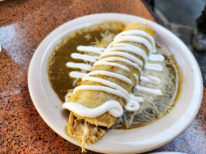 This burrito, dressed in its Sunday best with a drizzle of sour cream, is what food dreams are made of.