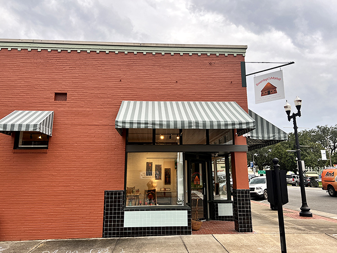This corner shop with its cheerful red facade and striped awnings invites passersby to step in and discover local treasures.