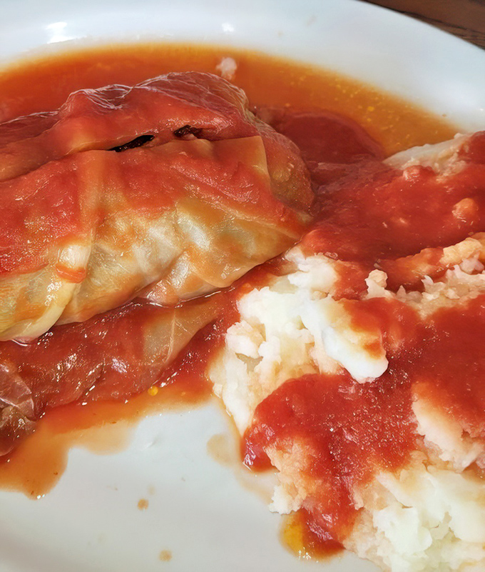 Cabbage rolls lounging in tomato sauce like they're at a spa&mdash;comfort food that whispers "someone's grandmother perfected this recipe."