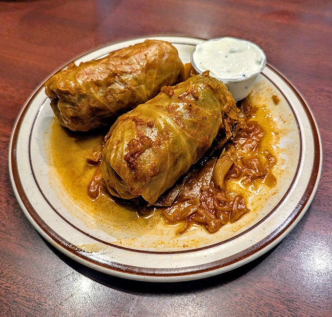 Hungarian cabbage rolls that would make your grandmother weep with joy, swimming in a sauce worth bottling and taking home.