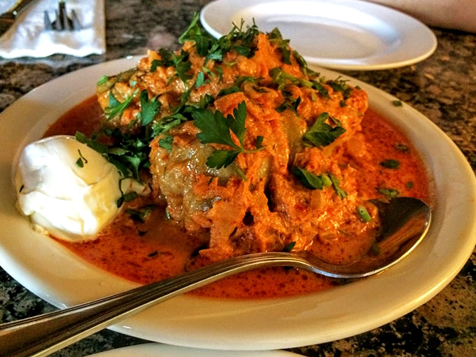 The legendary cabbage rolls arrive bathed in a vibrant sauce that would make even the most dedicated cabbage-hater reconsider their life choices.