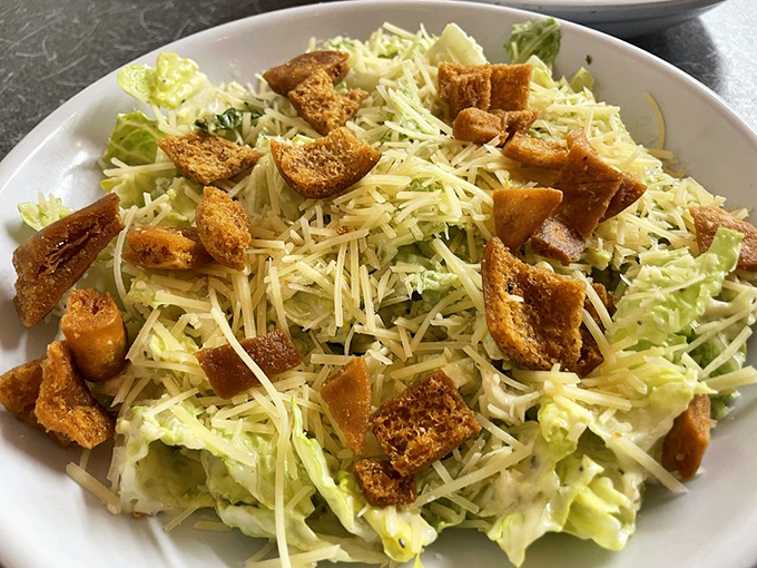 Caesar salad done right is a revelation, not an afterthought. Those homemade croutons deserve their own fan club and membership cards.