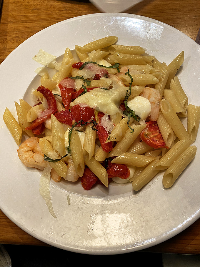 Penne pasta playing dress-up in its finest party clothes. Those shrimp and tomatoes aren't just ingredients&mdash;they're the life of the pasta party.