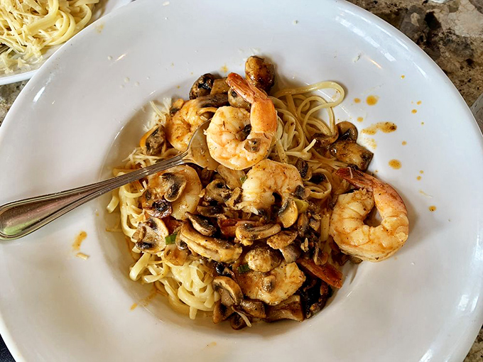 Plump shrimp and earthy mushrooms dance together atop al dente linguine—proof that pasta belongs at a seafood restaurant after all.