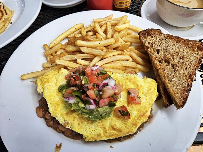 When an omelet meets California sunshine &ndash; fresh ingredients piled high with a side of perfectly crisped toast and golden fries.