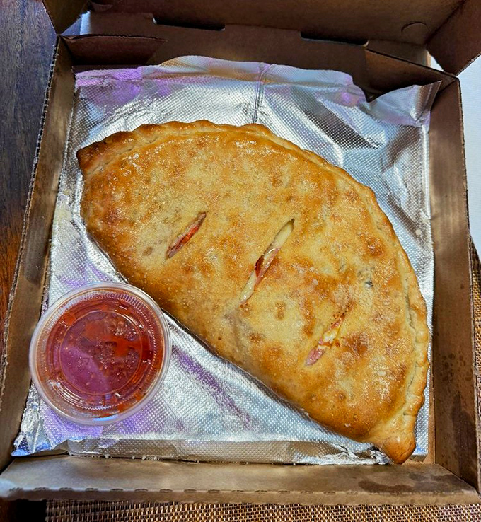 A calzone so beautiful it deserves its own ZIP code. The perfect portable feast with marinara on the side for essential dipping.