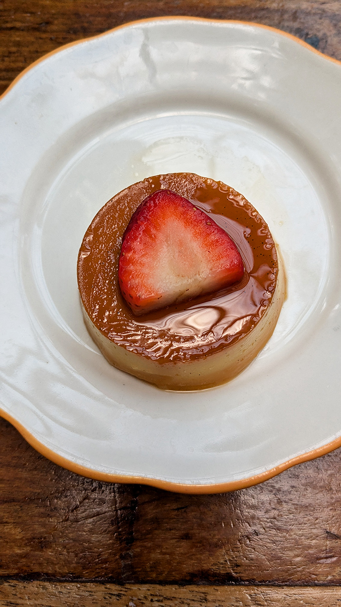 The flan that launched a thousand return visits. That caramel pool isn't just sauce&mdash;it's liquid gold that should be classified as a controlled substance.