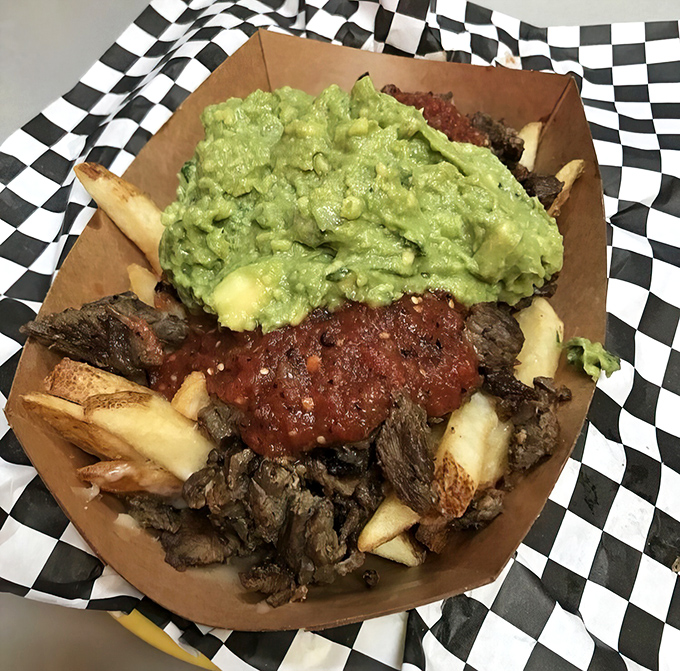 Carne asada fries: where potatoes fulfill their highest purpose by becoming a vessel for meat, guacamole, and pure happiness.