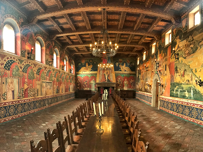 Feast like medieval royalty in this breathtaking great hall, where vibrant frescoes tell stories overhead while wine flows freely below.