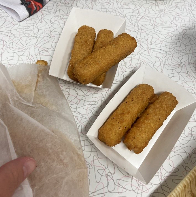 Cheese sticks that stretch for dramatic effect, proving that sometimes the simplest pleasures are the most satisfying.