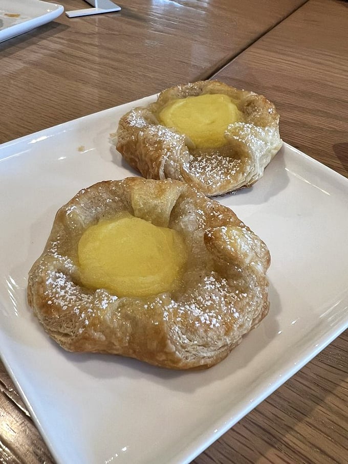 These Danish pastries cradle their lemon filling like precious cargo. The dusting of powdered sugar is the bakery equivalent of fairy dust.