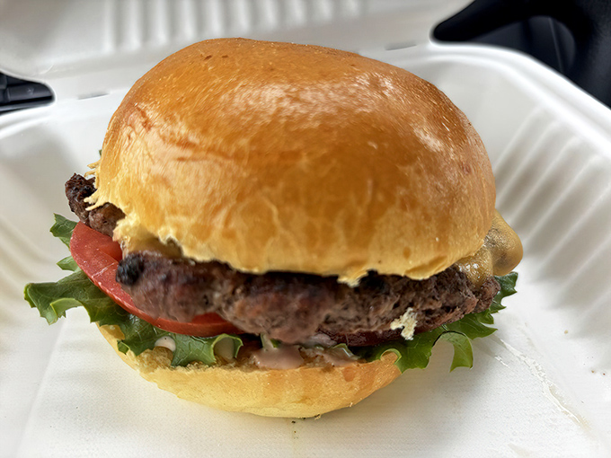 A perfectly proportioned burger on a golden brioche bun—proof that simplicity, when done right, beats complexity every time.