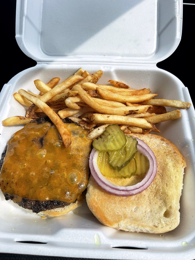 The classic cheeseburger and fries in their natural habitat&mdash;a styrofoam container that somehow makes everything taste better, like picnics and summer rolled into one.