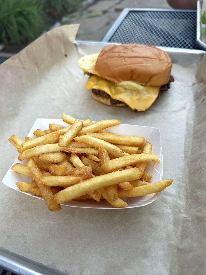 This isn't just a burger&mdash;it's architecture you can eat. Fresh lettuce, ripe tomato, and that perfectly charred patty create the skyline of Flavortown.
