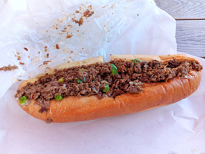The star of the show &ndash; a cheesesteak in its natural habitat. Chopped beef and green peppers mingling on a roll like old friends at a reunion.