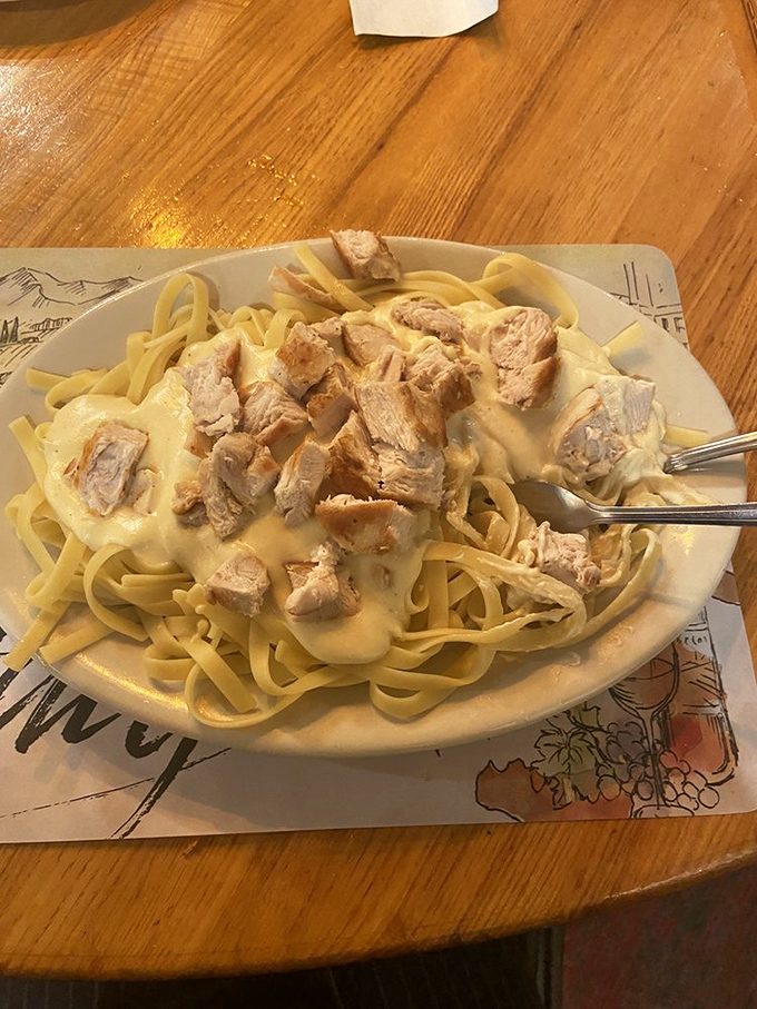 Fettuccine Alfredo with chicken chunks so generous they're practically showing off. This isn't just comfort food&mdash;it's a warm hug on a plate. 