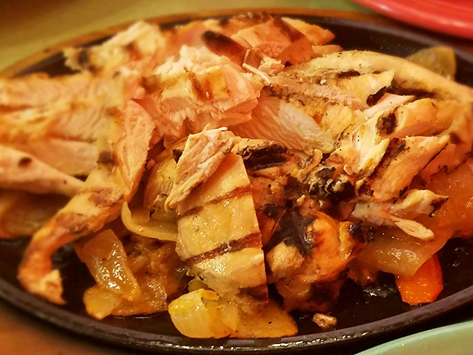 Chicken fajitas that don't just sizzle&mdash;they tell stories. Perfectly grilled with caramelized onions, they're the beach vacation your taste buds deserve.