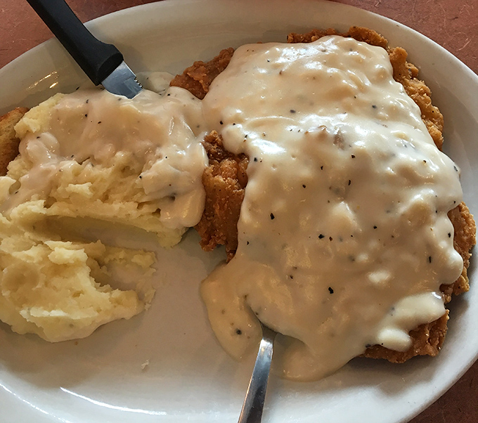 Country fried steak smothered in gravy alongside cloud-like mashed potatoes&mdash;comfort food that gives you a warm hug from the inside out.