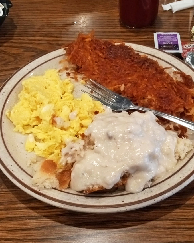 Chicken fried steak with country gravy: where comfort food meets artistic expression. The scrambled eggs provide a sunny supporting cast.
