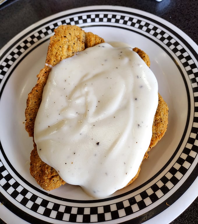 The star of the show&mdash;chicken fried steak wearing its cream gravy like a royal robe. No Instagram filter required.