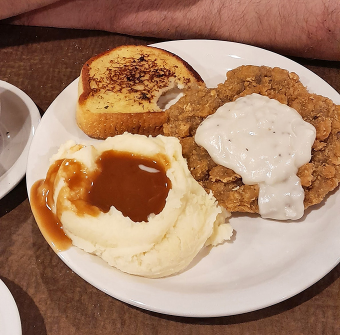 Southern comfort meets Pennsylvania appetite: chicken fried steak smothered in gravy alongside mashed potatoes that could make a grown adult weep with joy.