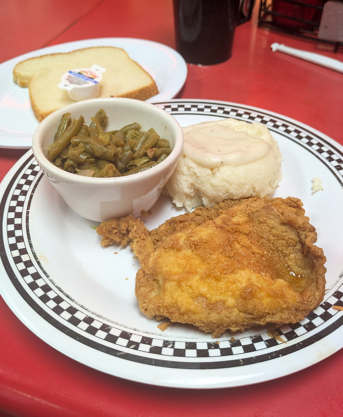 Country-fried steak with that perfect golden crust, served with green beans and mashed potatoes &ndash; the holy trinity of comfort food done right.