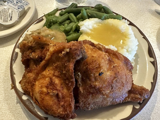 A plate that answers the eternal question: "What if happiness was a food?" Green beans, mashed potatoes, and chicken that makes you question all other chicken you've ever eaten.