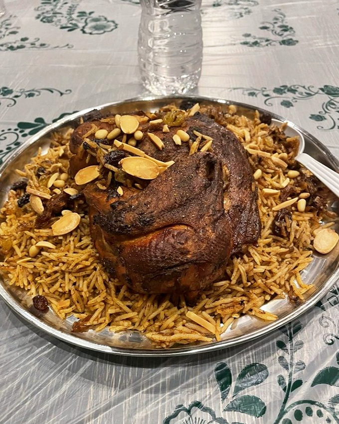 A feast fit for royalty! This magnificent lamb dish rests atop a bed of aromatic rice, creating a presentation that's as impressive as its flavor.