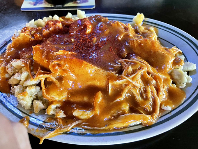 Chicken paprikas swimming in paprika sauce &ndash; it's like a warm hug from Budapest right here in Toledo.