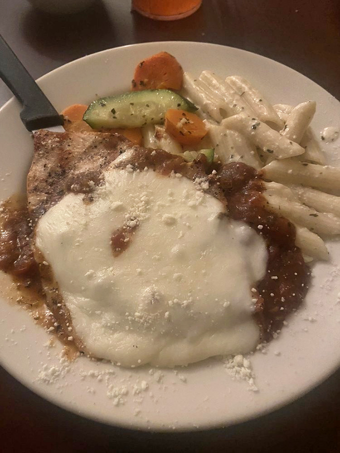 Chicken Parmesan that doesn't hide behind excess&mdash;just honest comfort food wearing a perfectly melted cheese blanket and a side of pasta. 