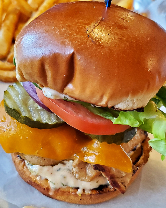 A burger that means business. Perfectly toasted bun, melty cheese, fresh veggies, and what looks like a special sauce that ties it all together in harmony.