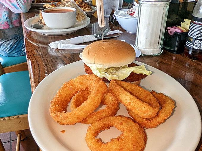 Golden onion rings that crunch louder than your childhood cereal. Paired with that perfectly toasted bun, it's a sandwich that demands to be noticed.