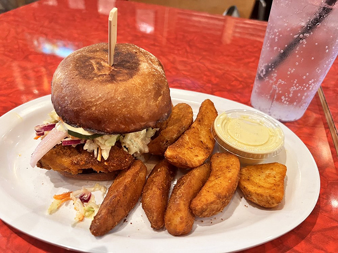 Not just a sandwich, but an architectural masterpiece of crispy chicken, slaw, and sauce on a perfectly toasted bun. Worth every napkin you'll need.