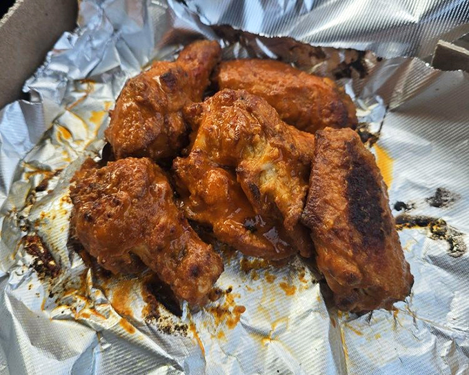 Wings so saucy they require a commitment. These aren't first-date food unless you're testing if they'll still like you with orange sauce on your chin.