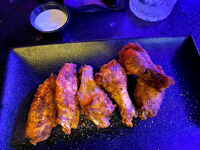 Wings get the full gothic treatment with sauces that pack flavor and visual drama.